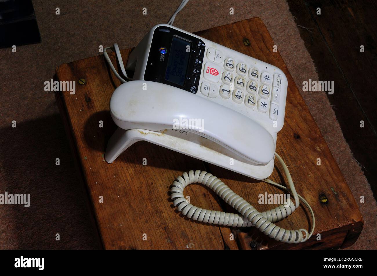Old fashioned white corded telephone with large numbers Stock Photo - Alamy