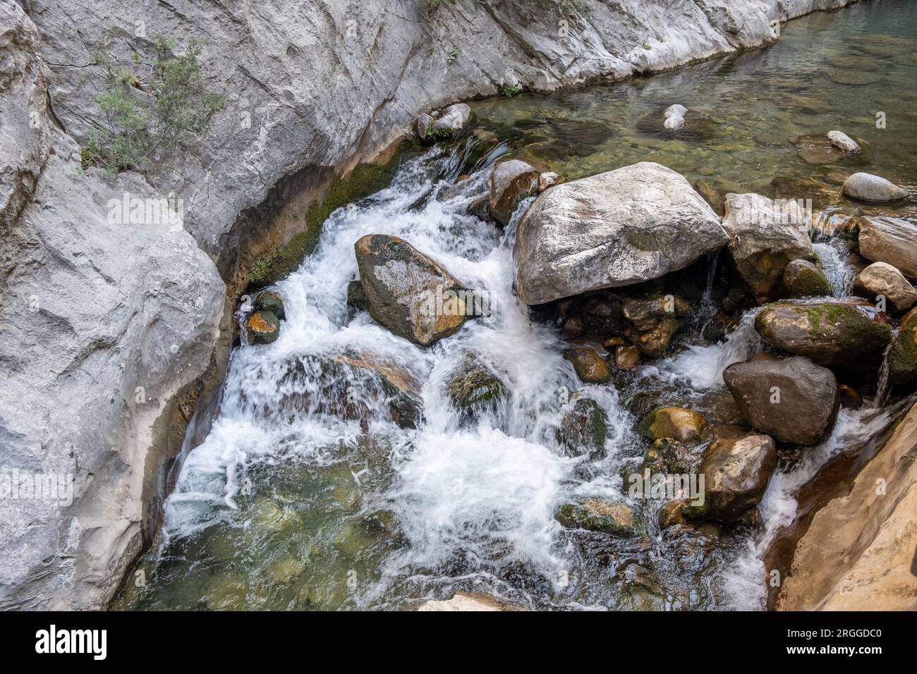 A beautiful mountain gorge with a river and a waterfall Stock Photo - Alamy