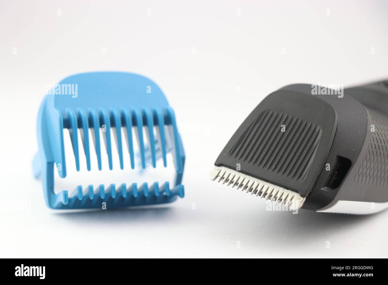 Wireless hair trimmer with a view of its blade and an attachment to ...