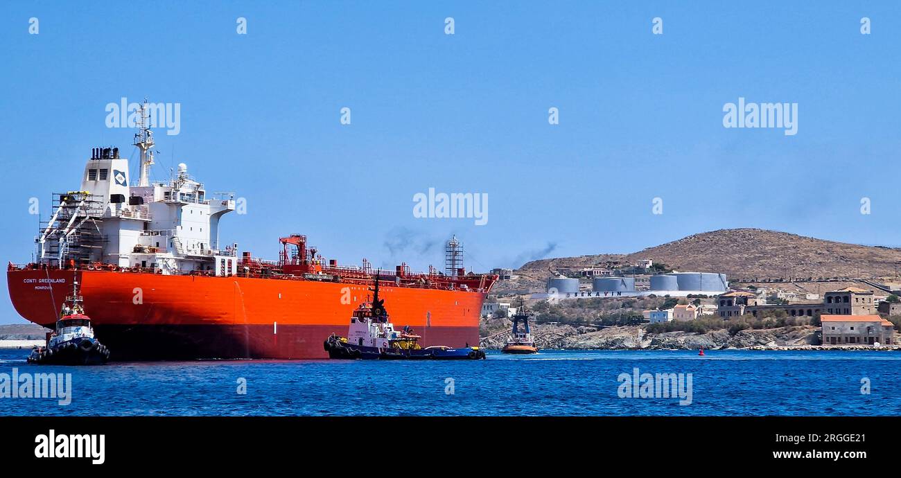 Tugs towing a ship to Onex Neorion Shipyard, Syros island, Greece ...