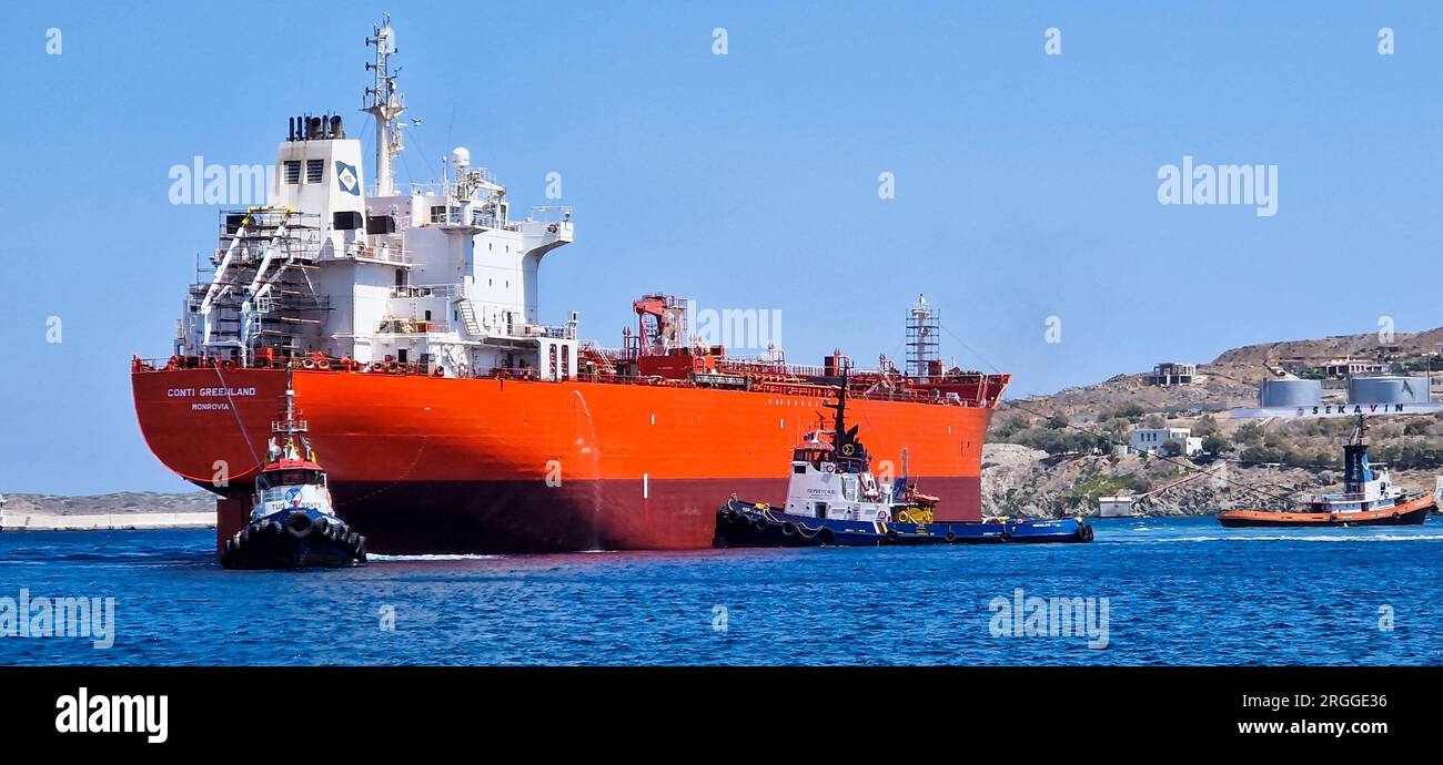 Tugs towing a ship to Onex Neorion Shipyard, Syros island, Greece ...