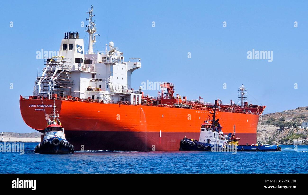 Tugs towing a ship to Onex Neorion Shipyard, Syros island, Greece ...