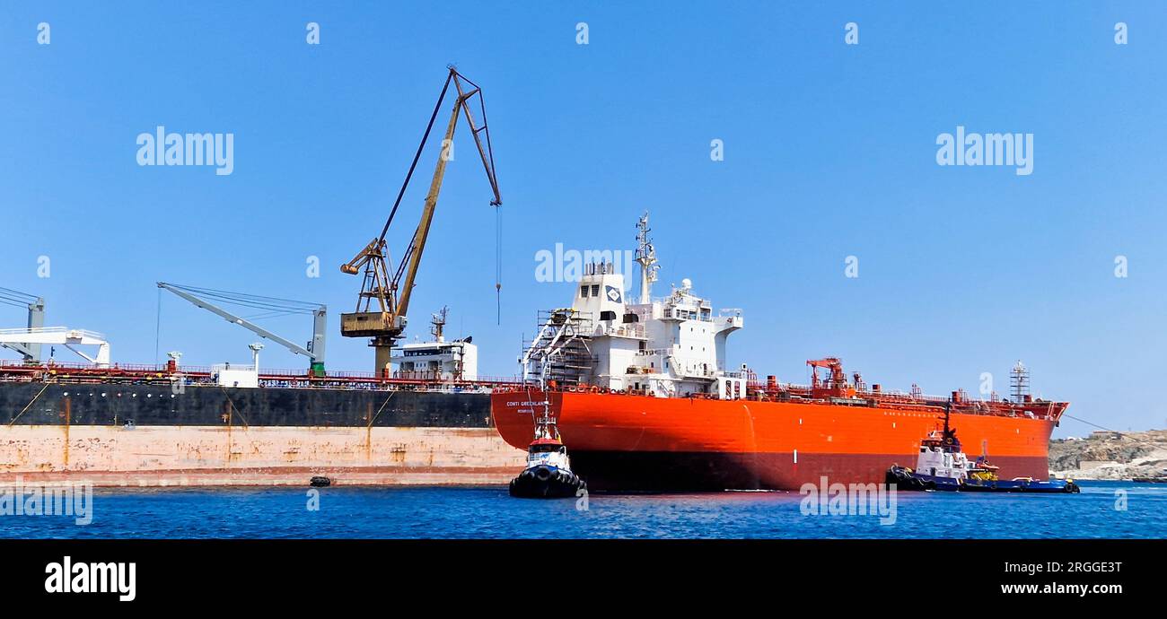 Tugs towing a ship to Onex Neorion Shipyard, Syros island, Greece ...