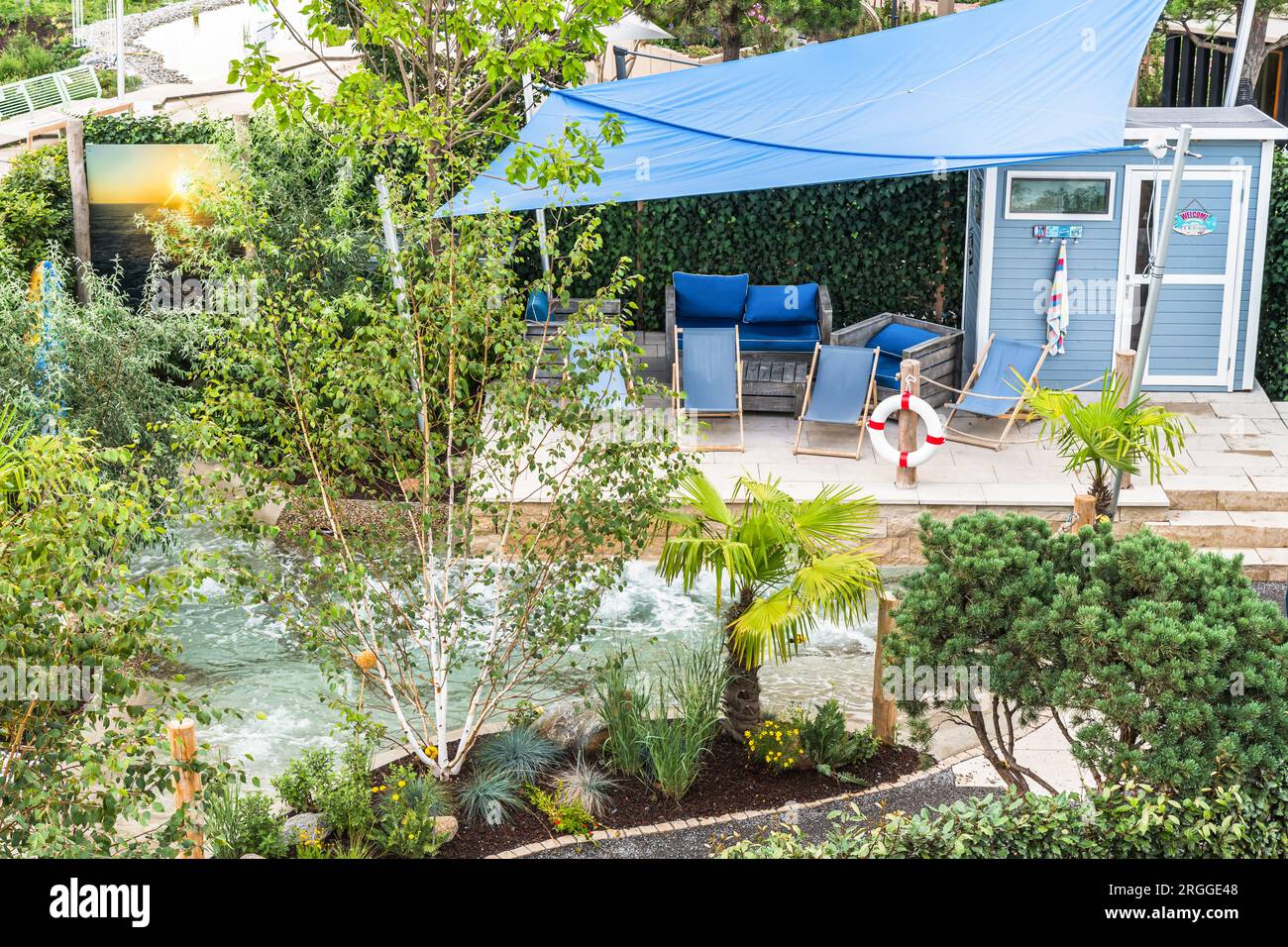 Top view of a terrace with sun loungers by a modern built-in swimming ...
