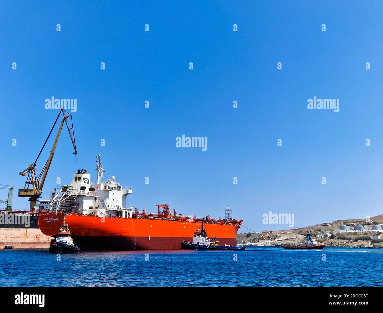 Tugs towing a ship to Onex Neorion Shipyard, Syros island, Greece ...