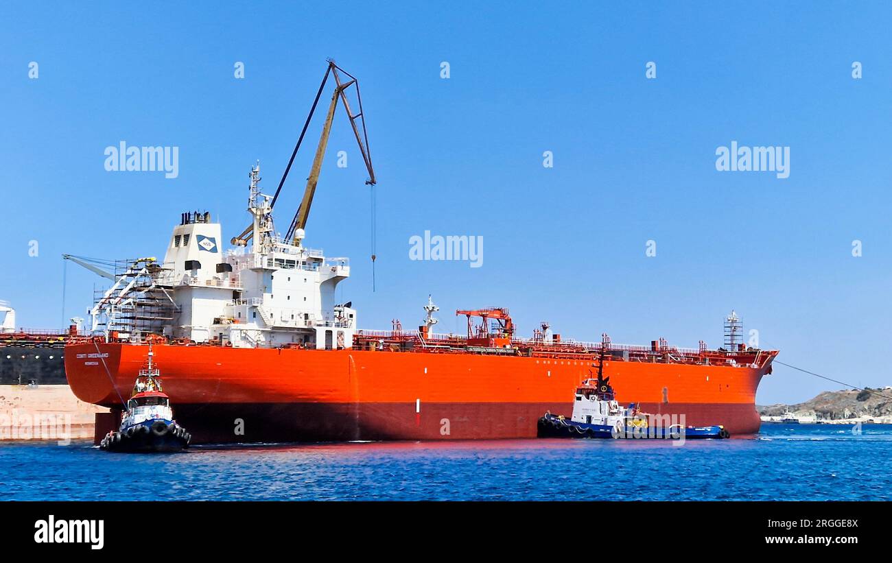 Tugs towing a ship to Onex Neorion Shipyard, Syros island, Greece ...