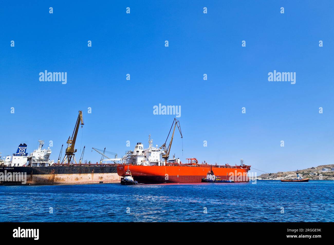 Tugs towing a ship to Onex Neorion Shipyard, Syros island, Greece ...