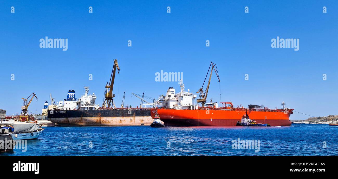 Tugs towing a ship to Onex Neorion Shipyard, Syros island, Greece ...