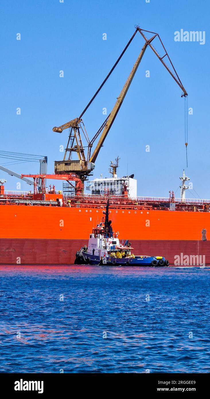 Tugs towing a ship to Onex Neorion Shipyard, Syros island, Greece ...