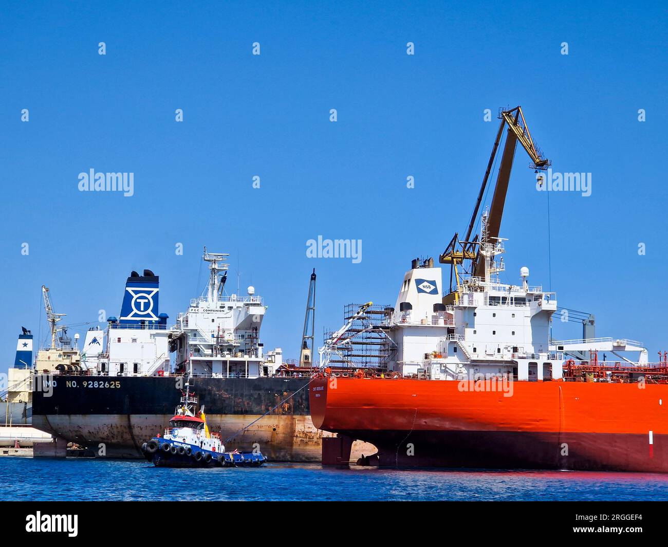 Tugs towing a ship to Onex Neorion Shipyard, Syros island, Greece ...