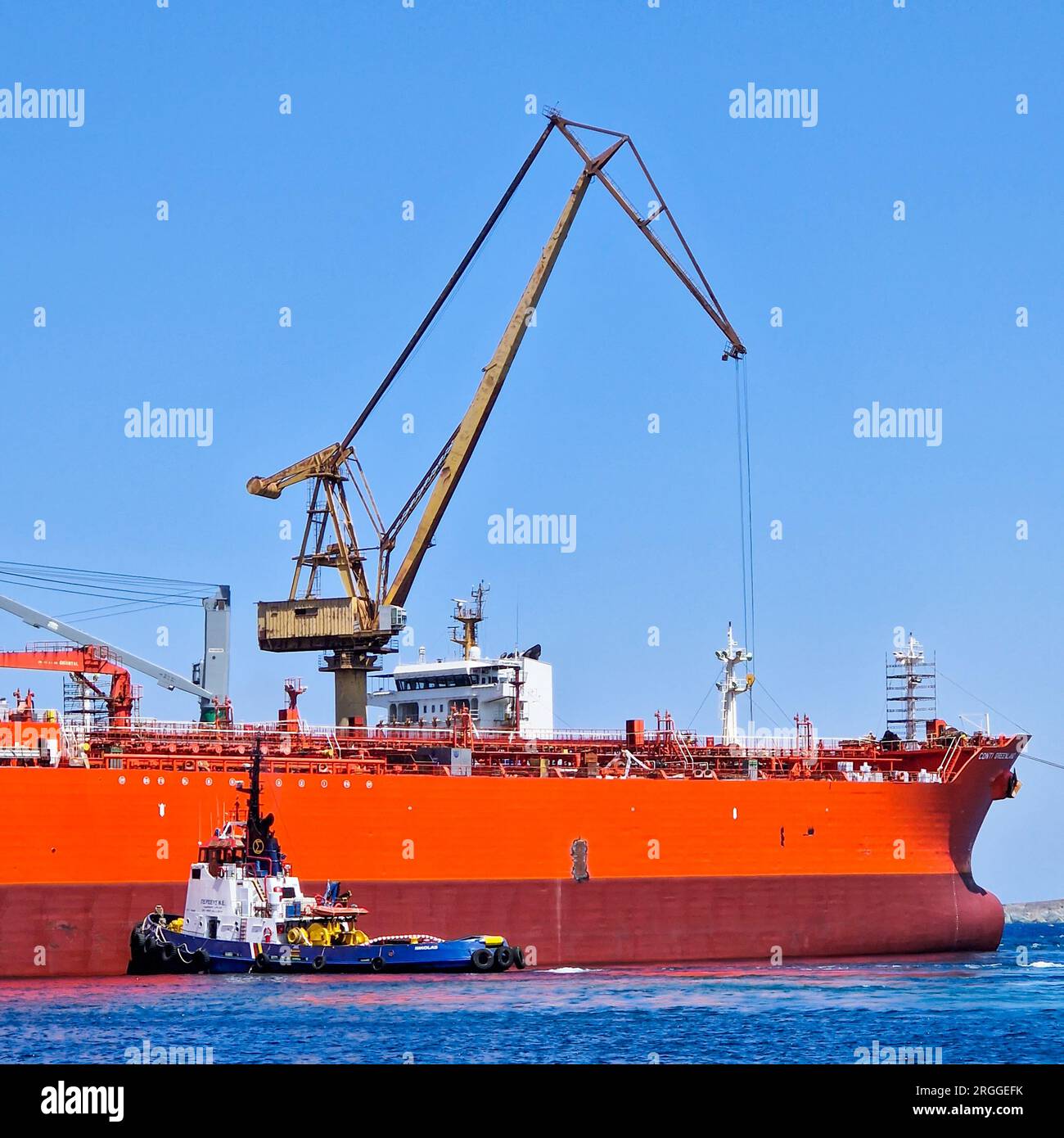 Tugs towing a ship to Onex Neorion Shipyard, Syros island, Greece ...