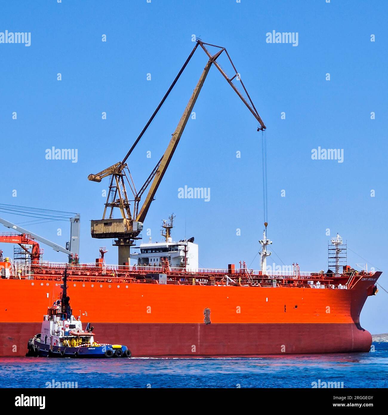 Tugs towing a ship to Onex Neorion Shipyard, Syros island, Greece ...