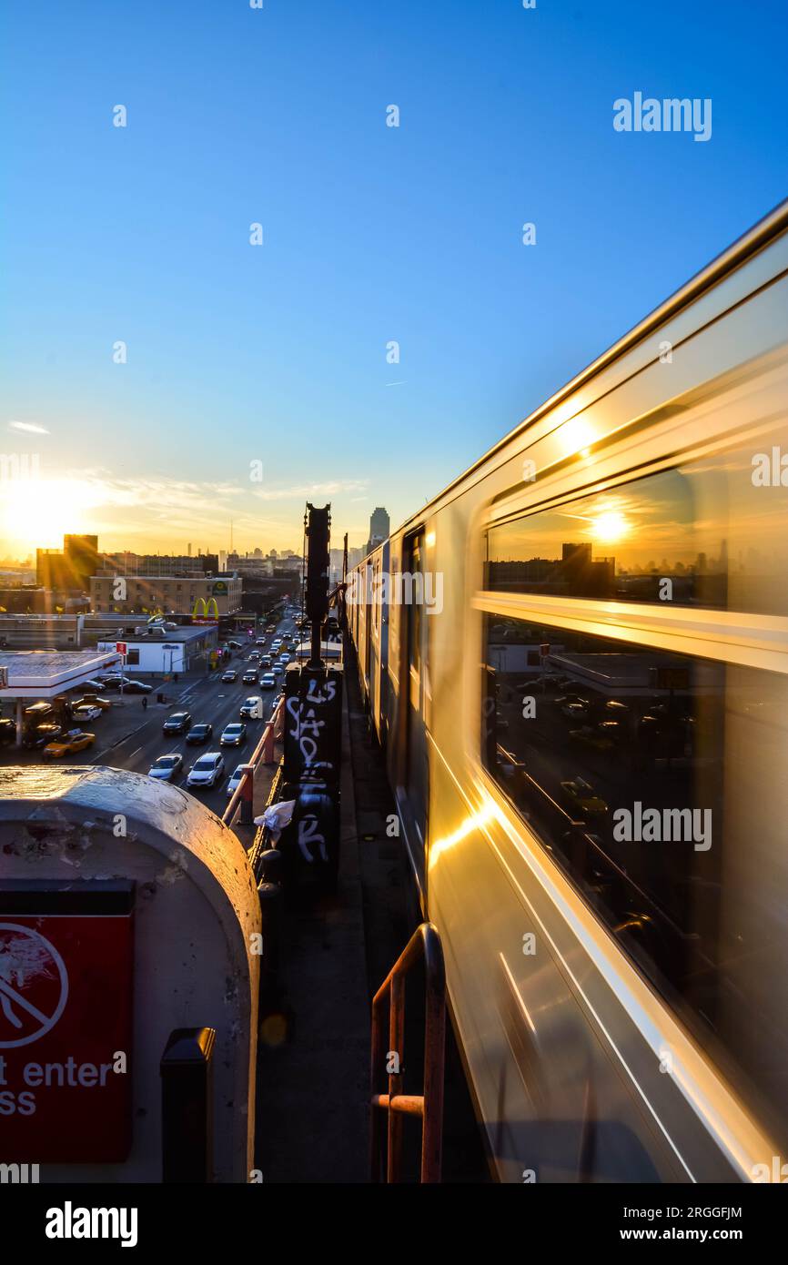 Moving subway train with NYC queens background Stock Photo - Alamy