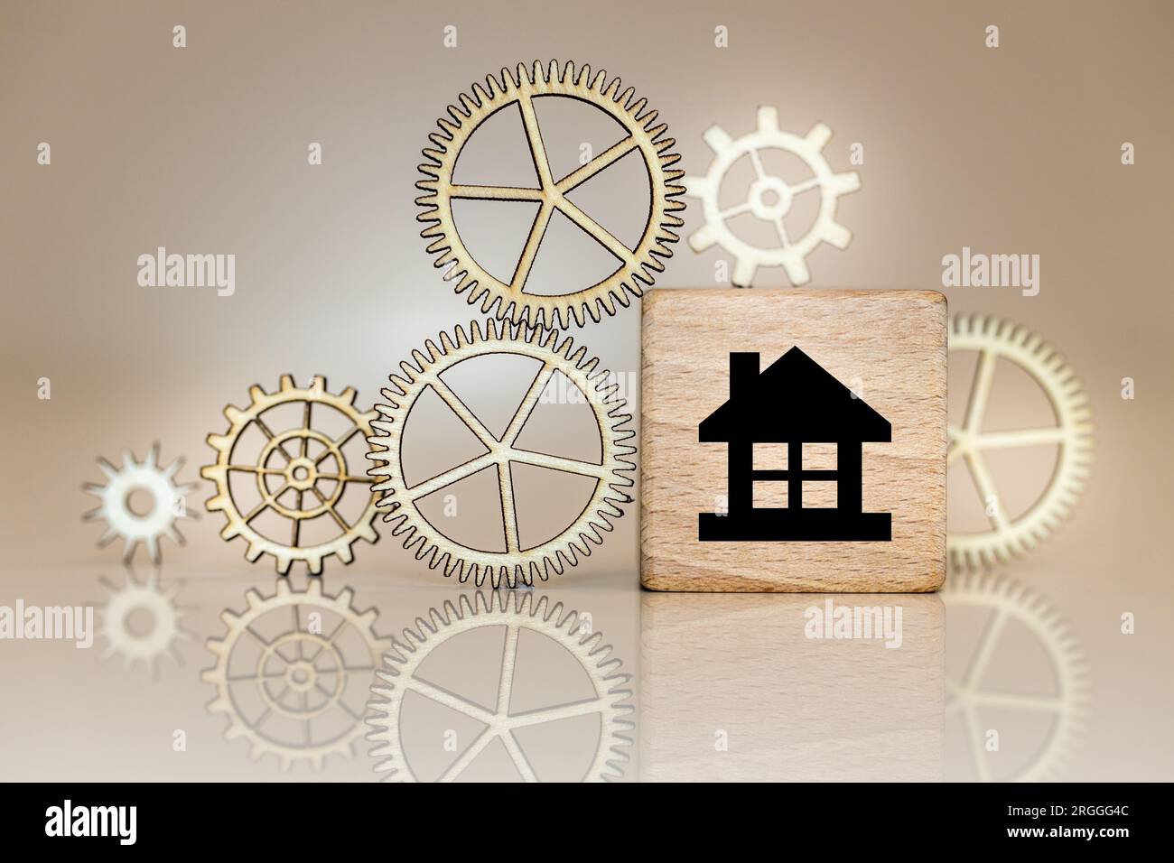 House symbol on a wooden block, clock gears and mechanisms, smart home ...