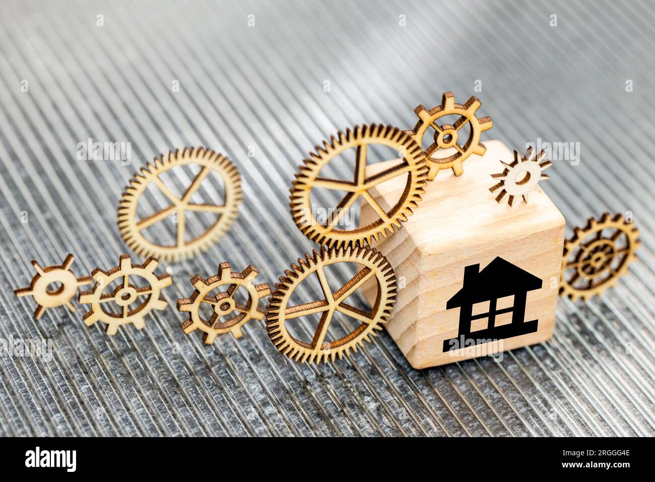 House symbol on a wooden block, clock gears and mechanisms, smart home ...