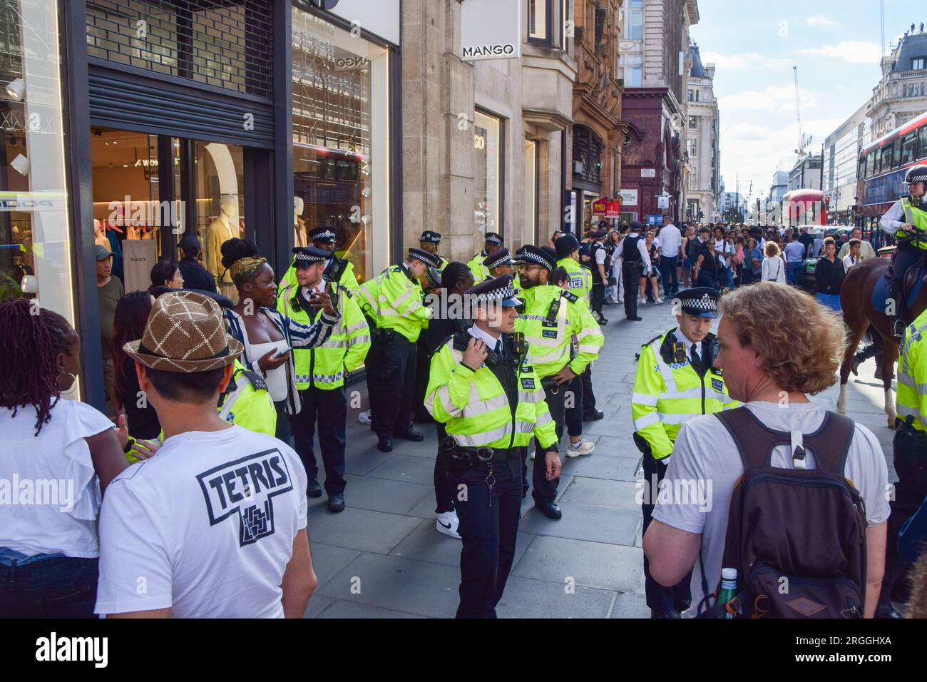 London, UK. 9th August 2023. Police officers detain a young man on ...