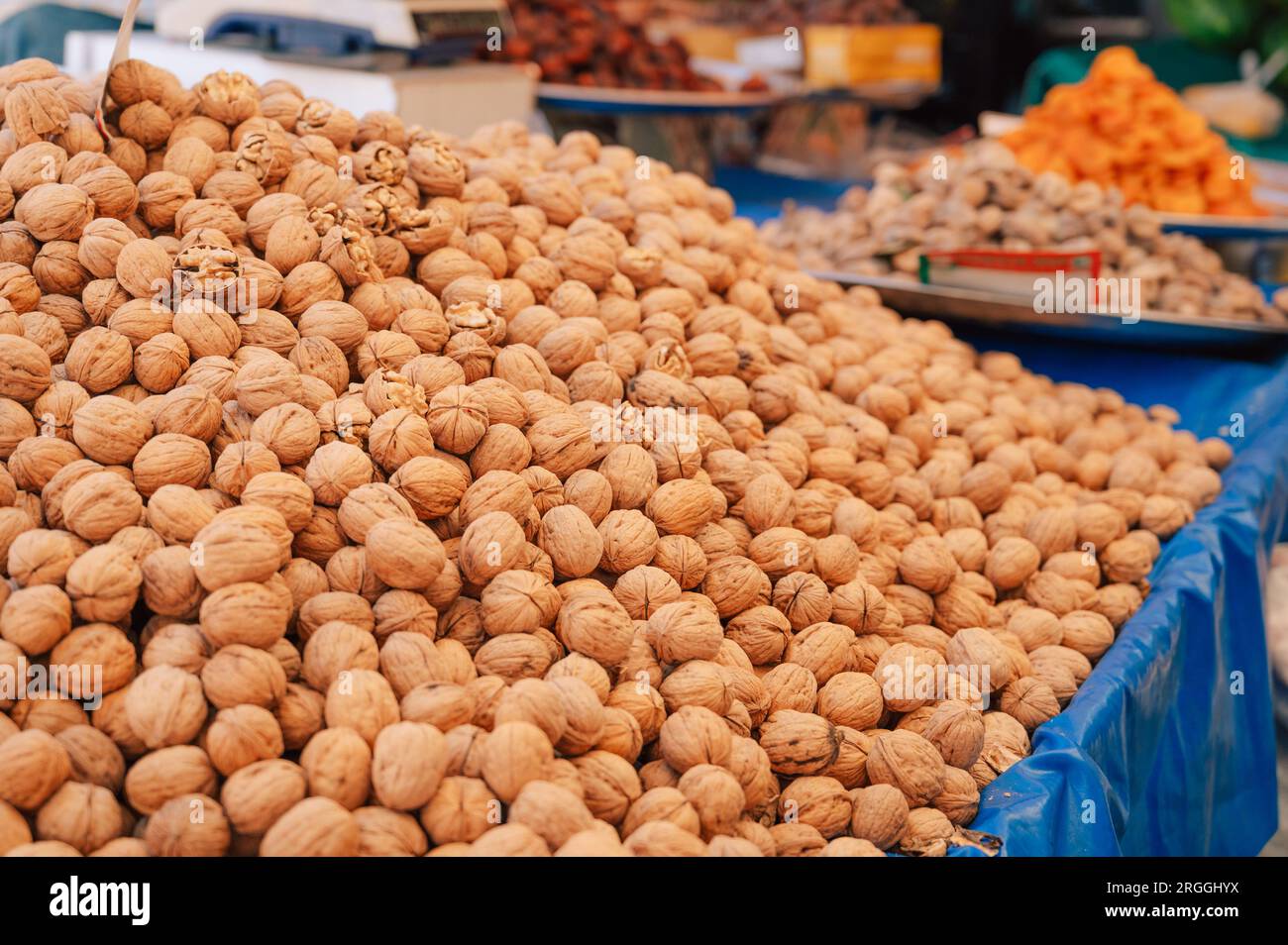 Walnut sale in the traditional farm Turkish market, a counter filled ...