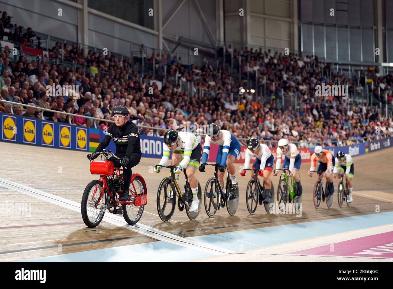 Competitors follow the derny bike during the Men Elite Keirin semi ...