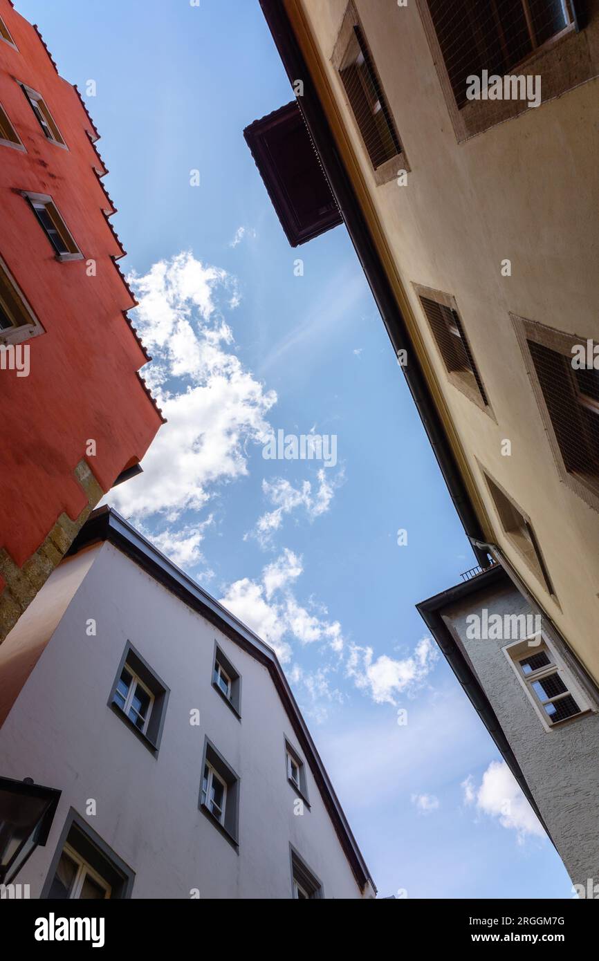 View of houses from bottom up and blue sky. Unusual roofs and colorful ...