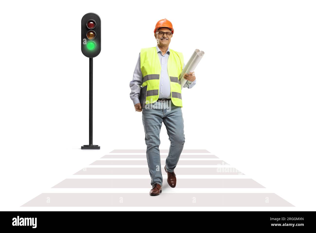 Mature male engineer holding blueprints and walking at a pedestrian ...