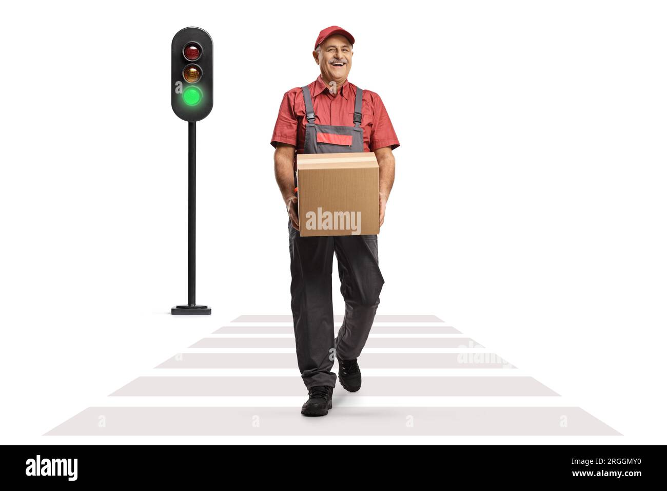 Delivery man walking and carrying a cardboard box at a pedestrian ...