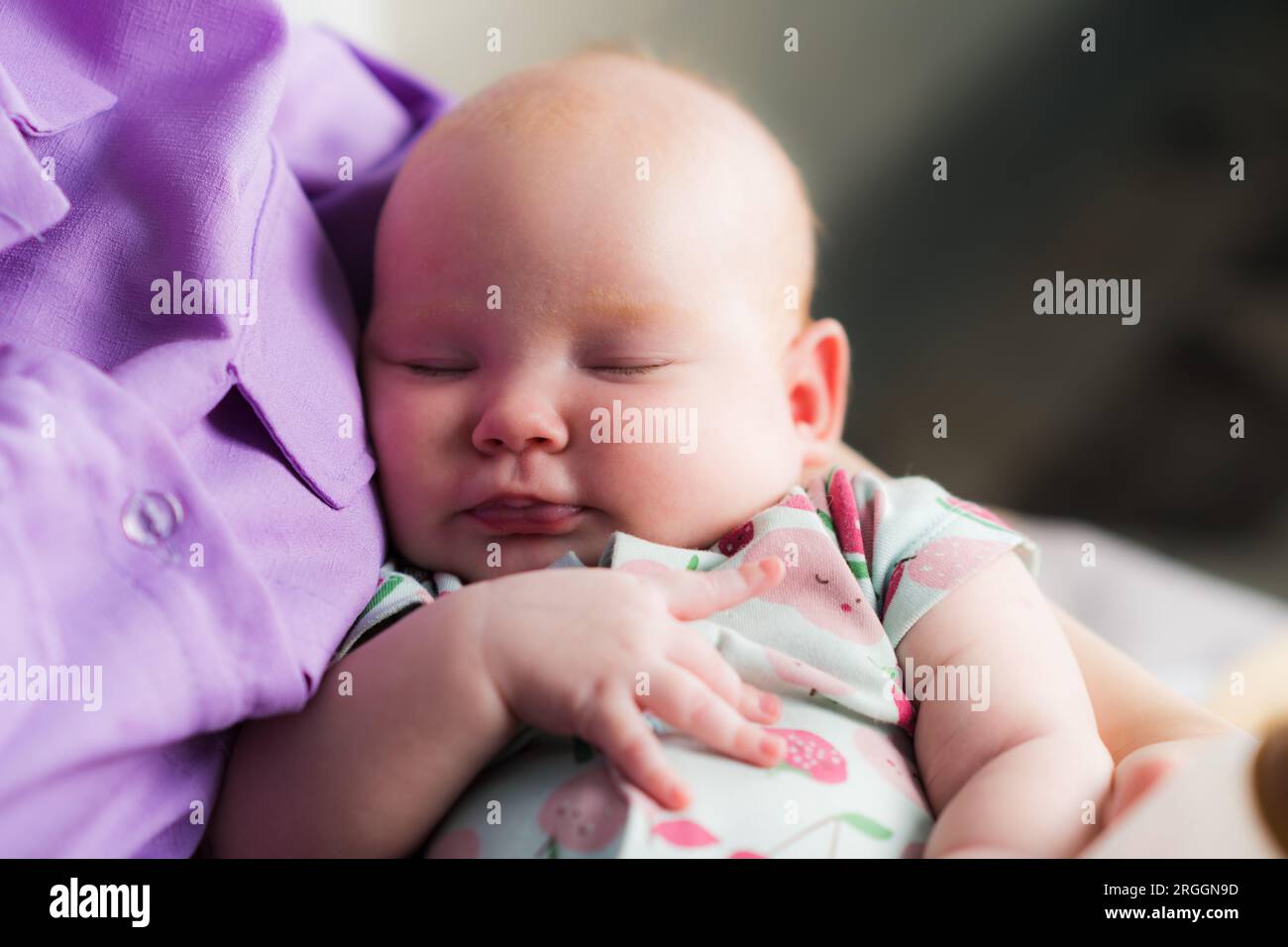 Cute newborn baby girl sleeping in her mothers arms, closeup Stock Photo - Alamy