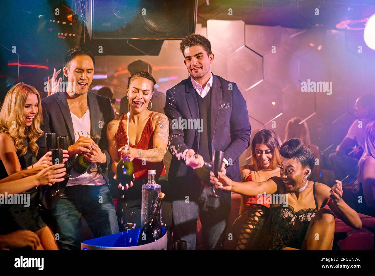 Friends celebrating at nightclub Stock Photo - Alamy