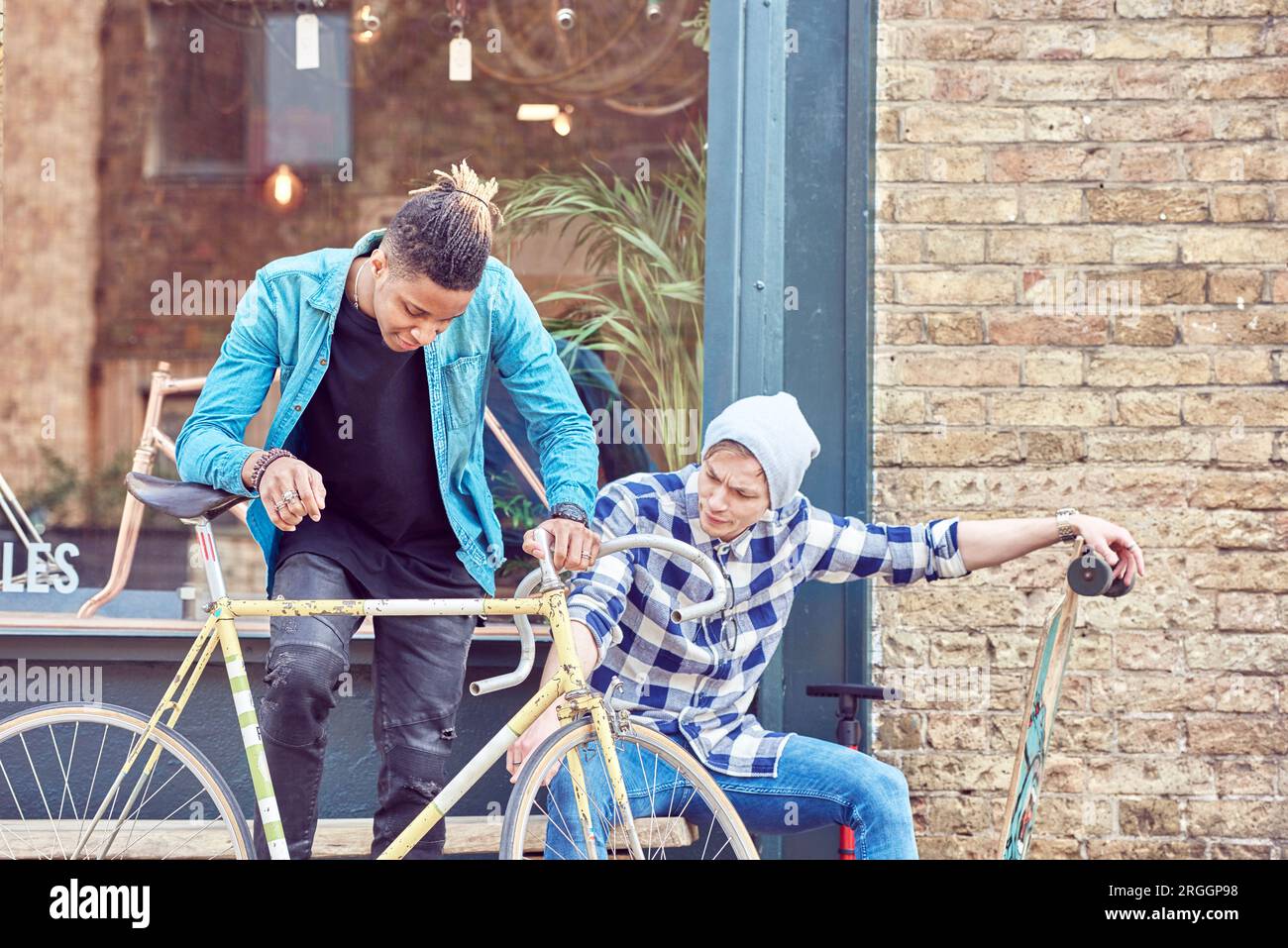 Teenage boy on bicycle talking to his friend Stock Photo - Alamy