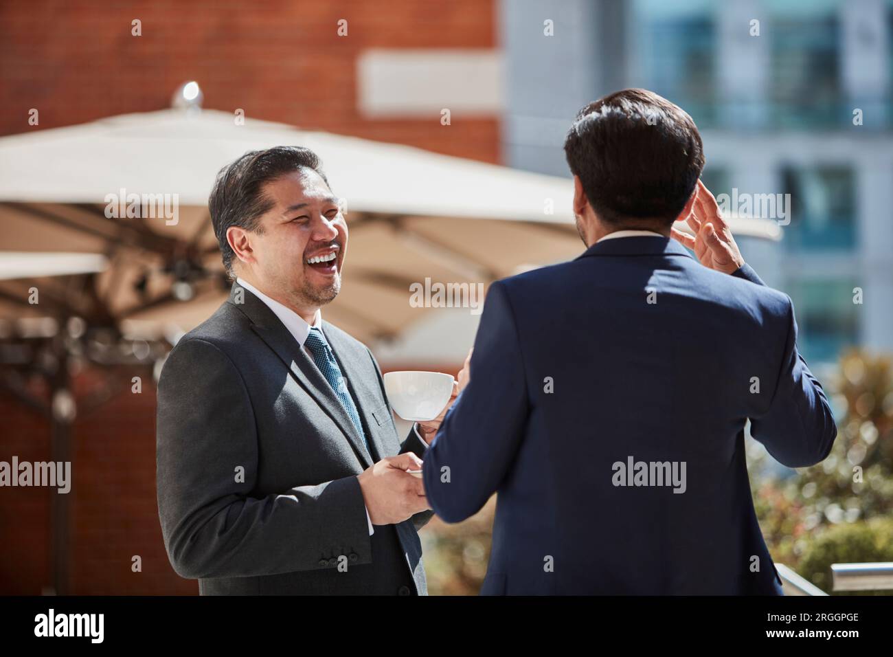 Laughing businessmen with coffee hi-res stock photography and images ...