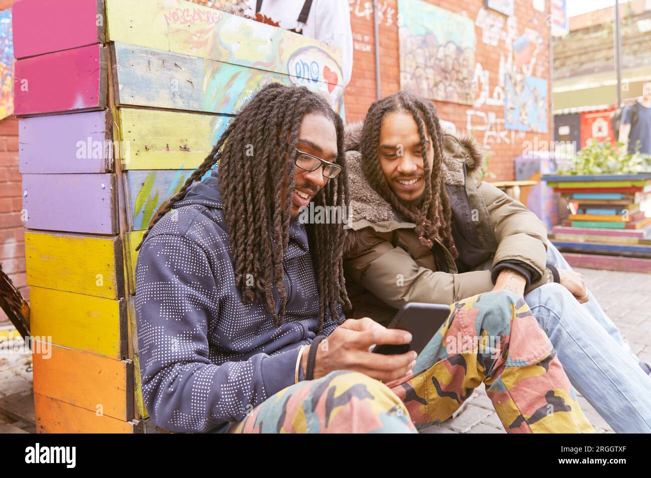 Men sitting together hi-res stock photography and images - Alamy