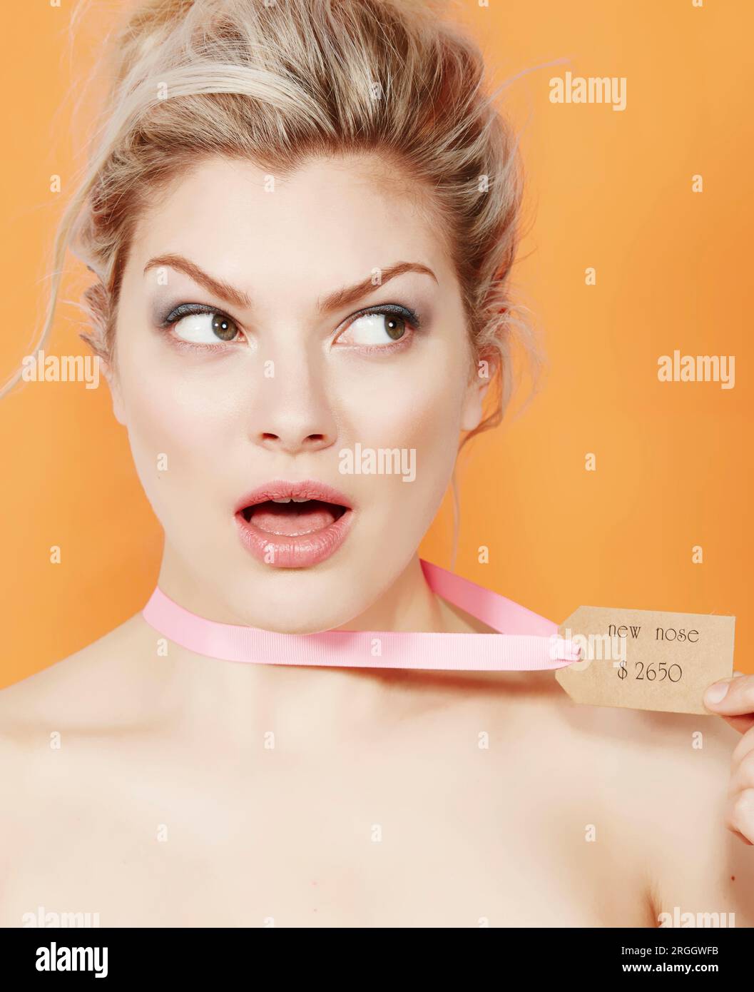 Young woman wearing price tag Stock Photo - Alamy