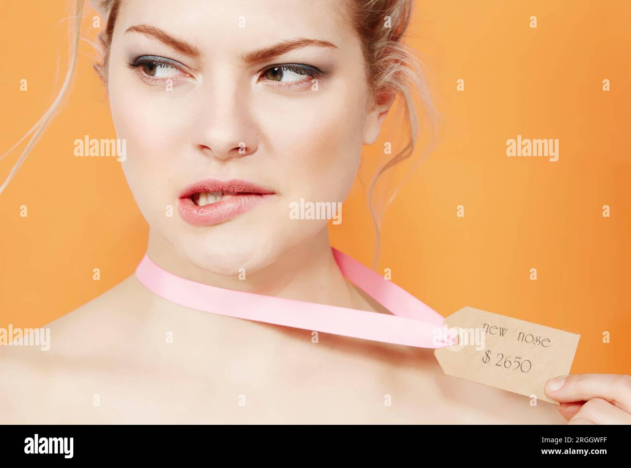 Young woman wearing price tag Stock Photo - Alamy
