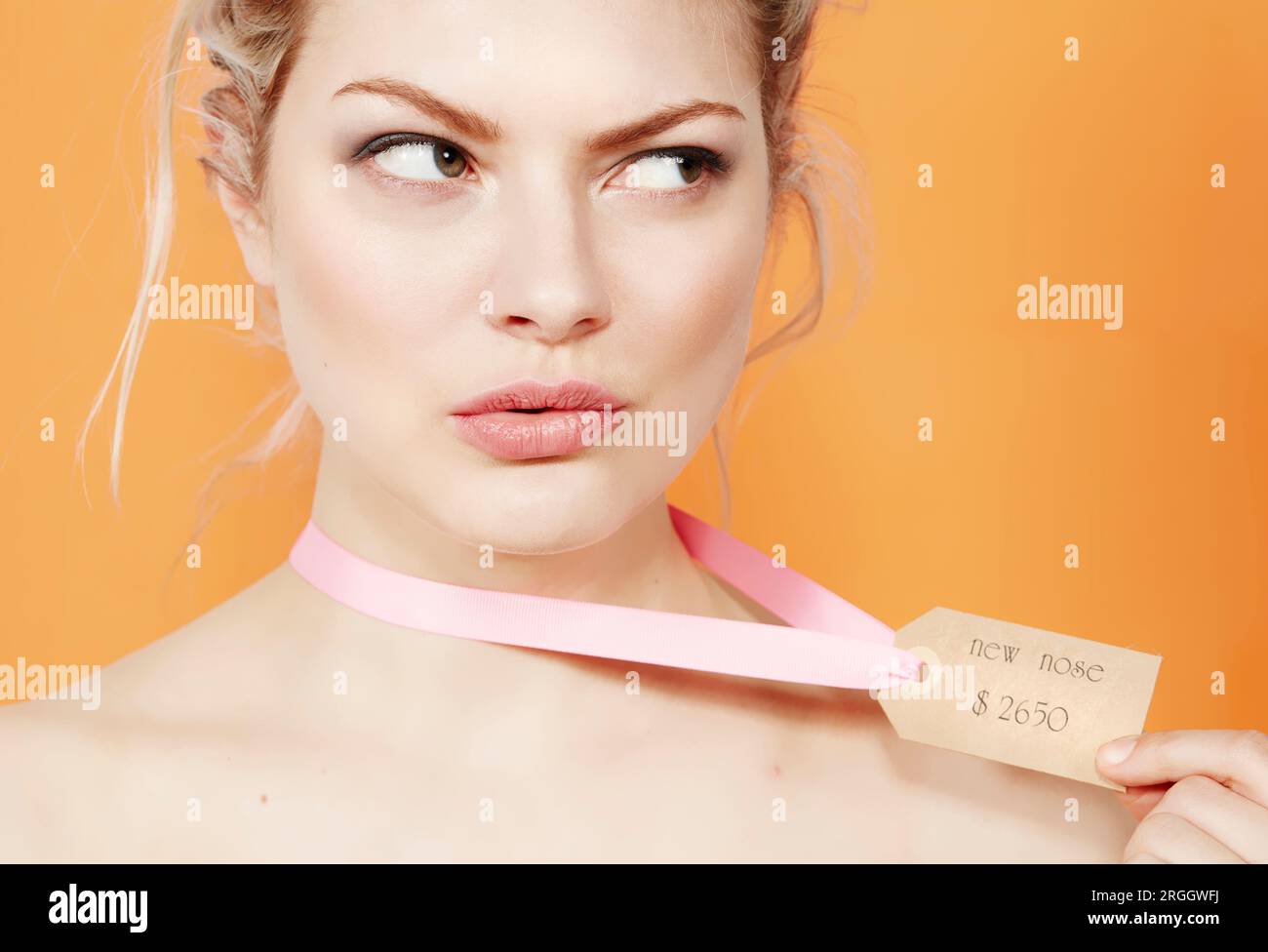 Young woman wearing price tag Stock Photo - Alamy