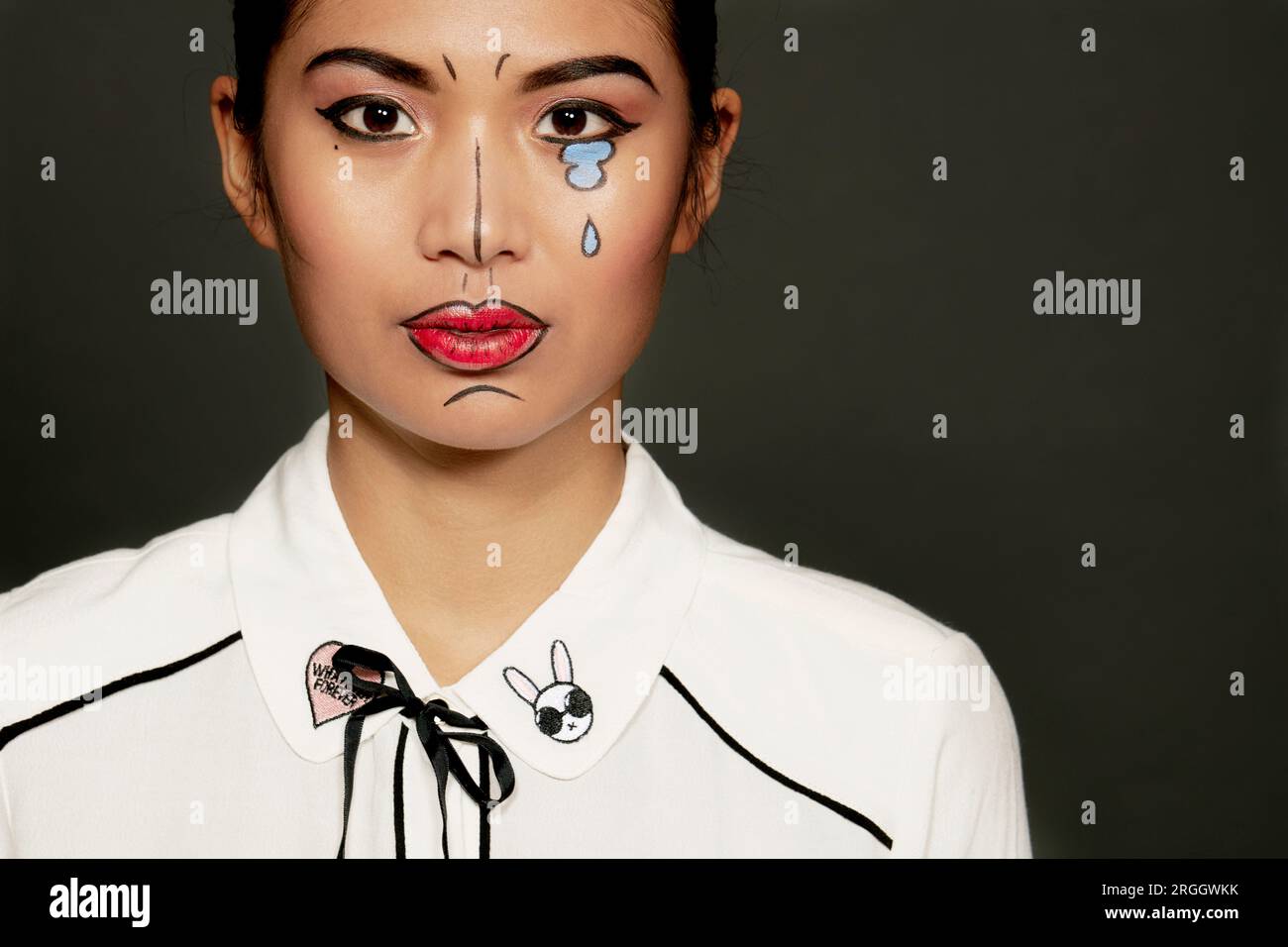 Young woman with face paint tears and lines Stock Photo - Alamy
