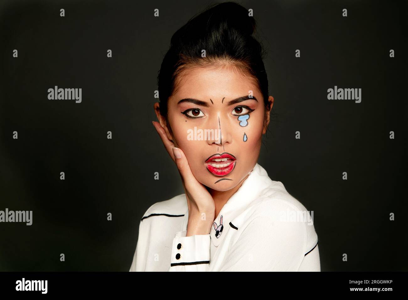 Young woman with face paint tears and lines Stock Photo - Alamy