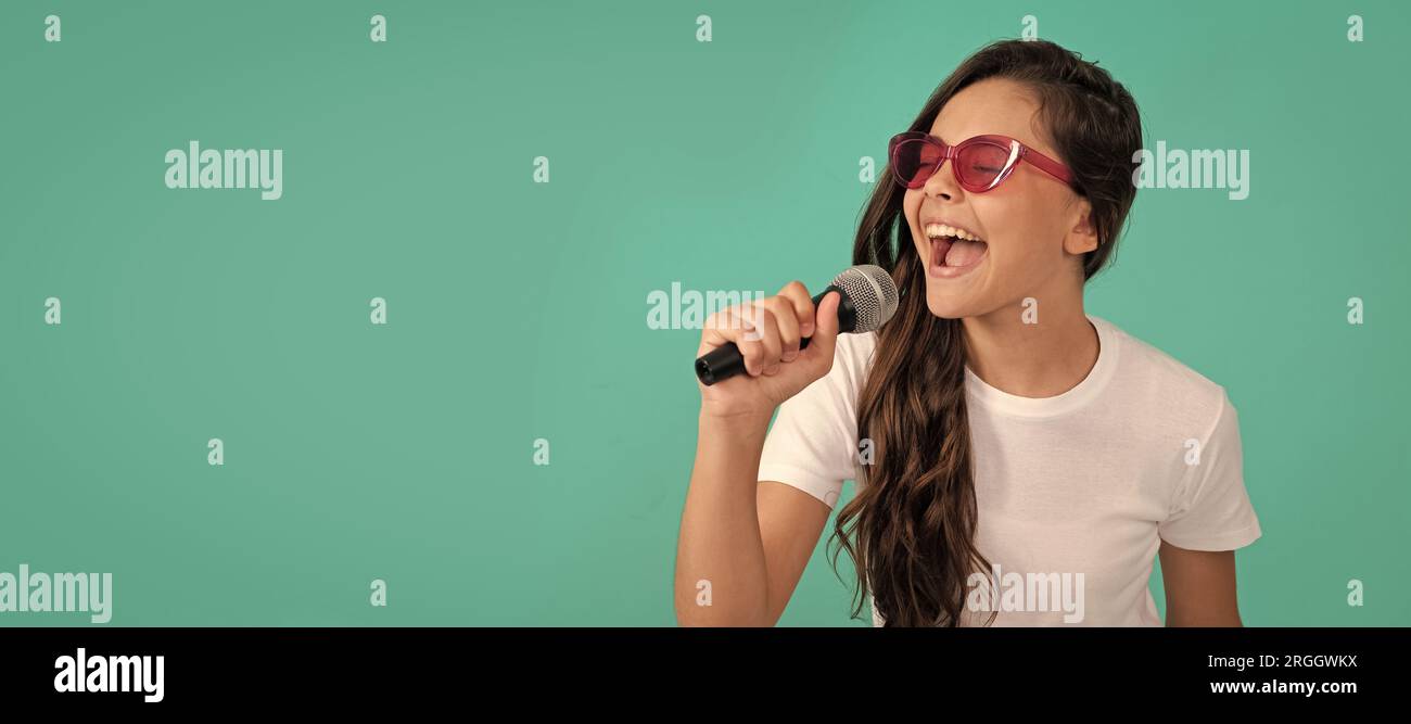 Have fun at karaoke. Karaoke child singer blue background. Happy kid ...