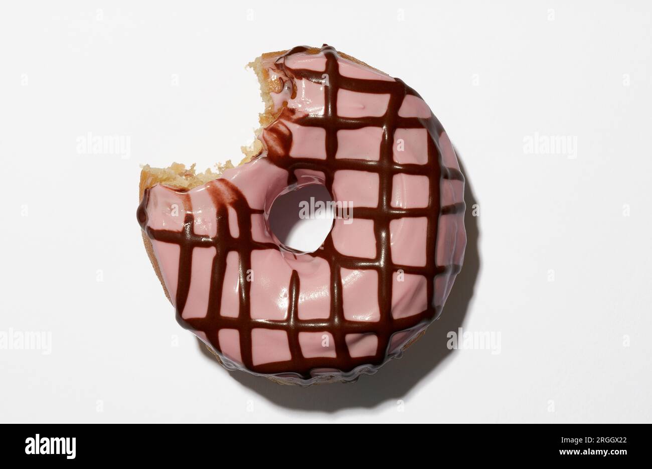 Doughnut with missing bite and pink icing Stock Photo - Alamy
