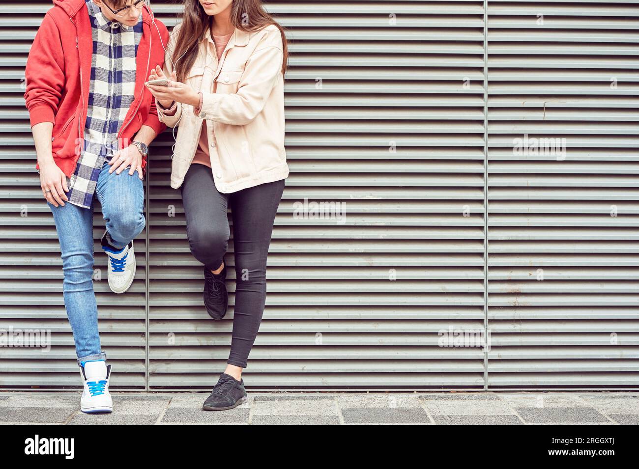 Female and male sharing headphones hi-res stock photography and images ...
