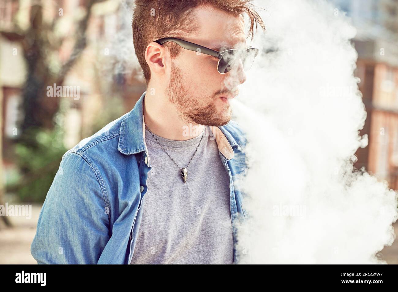 Teenage boy smoking Stock Photo - Alamy