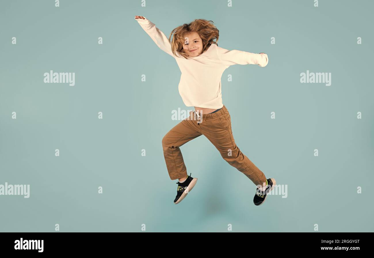 Funny boy jumping. Full length photo of kid boy jump high wear casual ...