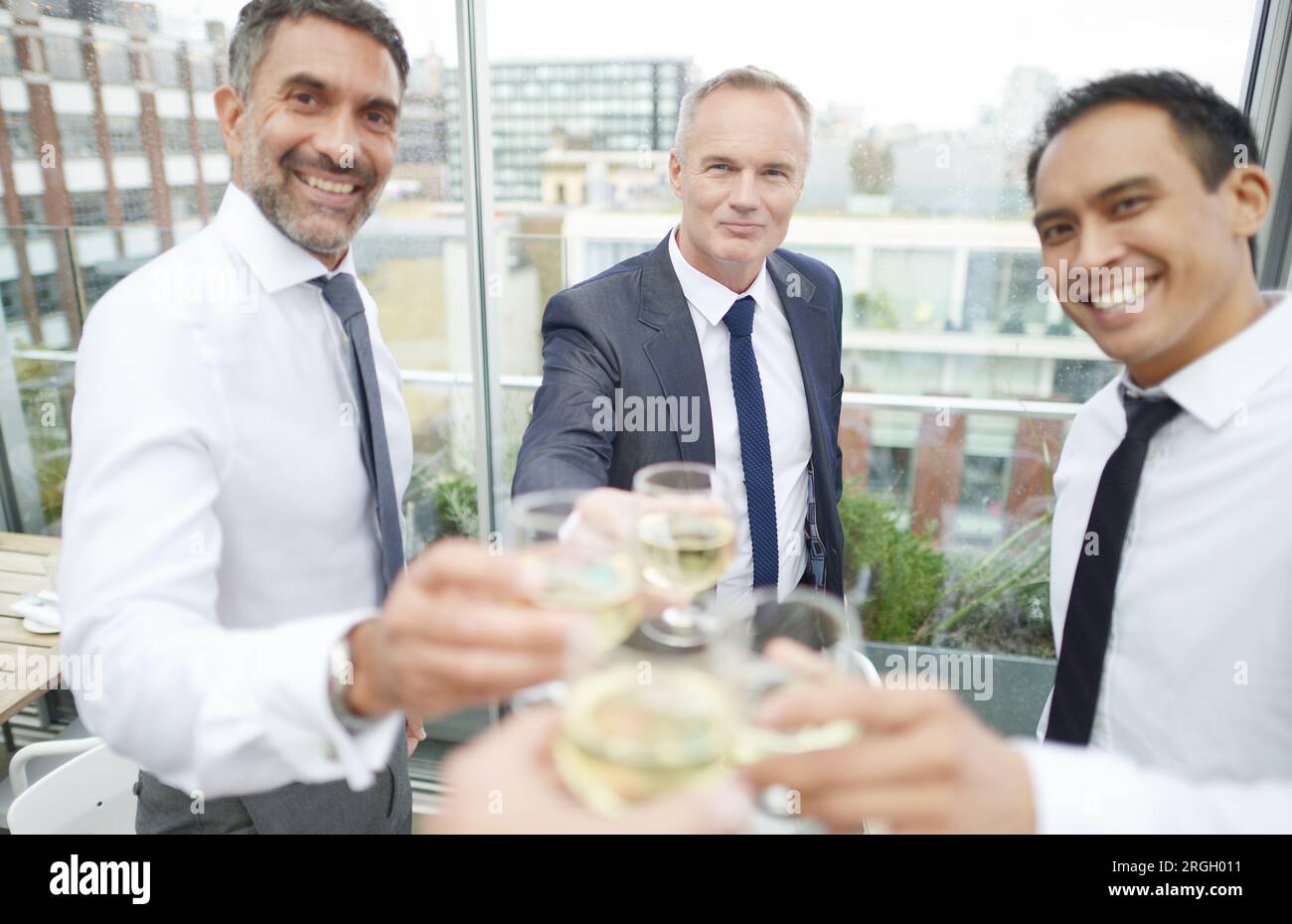 Businessmen toasting during meeting at restaurant Stock Photo - Alamy