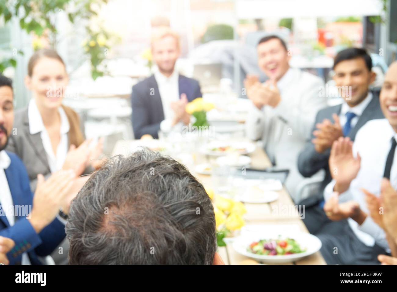 Businesspeople smiling and clapping in restaurant Stock Photo - Alamy