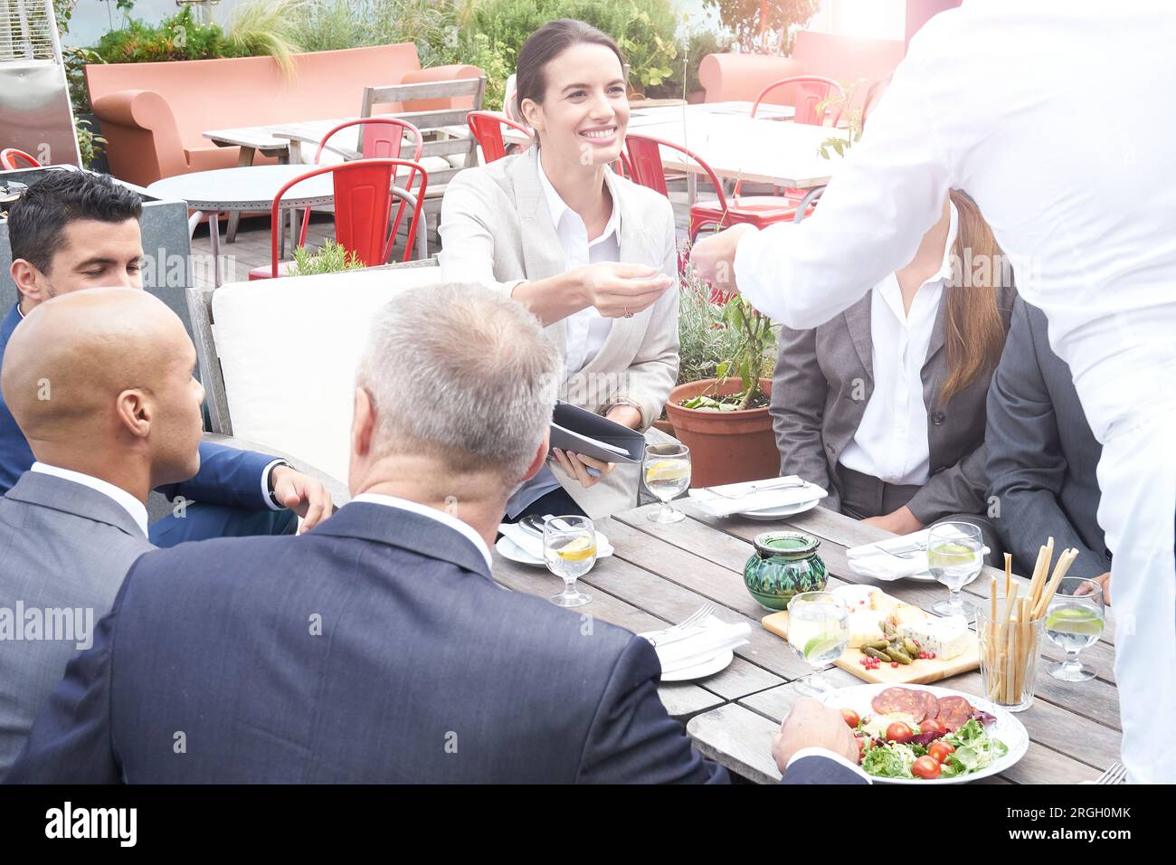 Businesspeople around a table at a restaurant meeting Stock Photo - Alamy