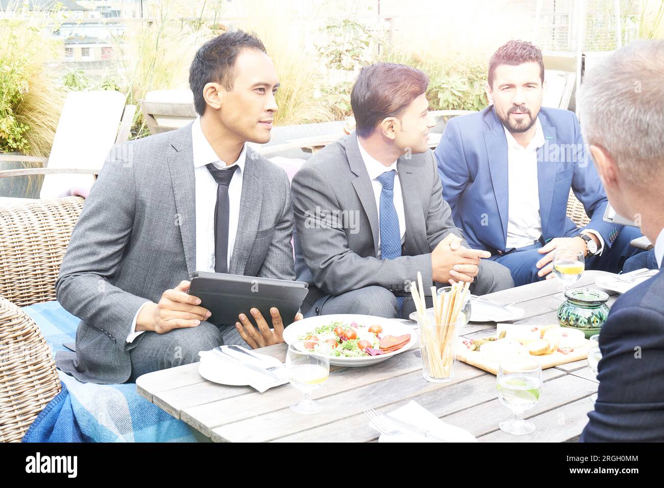 Group people around wooden table hi-res stock photography and images ...