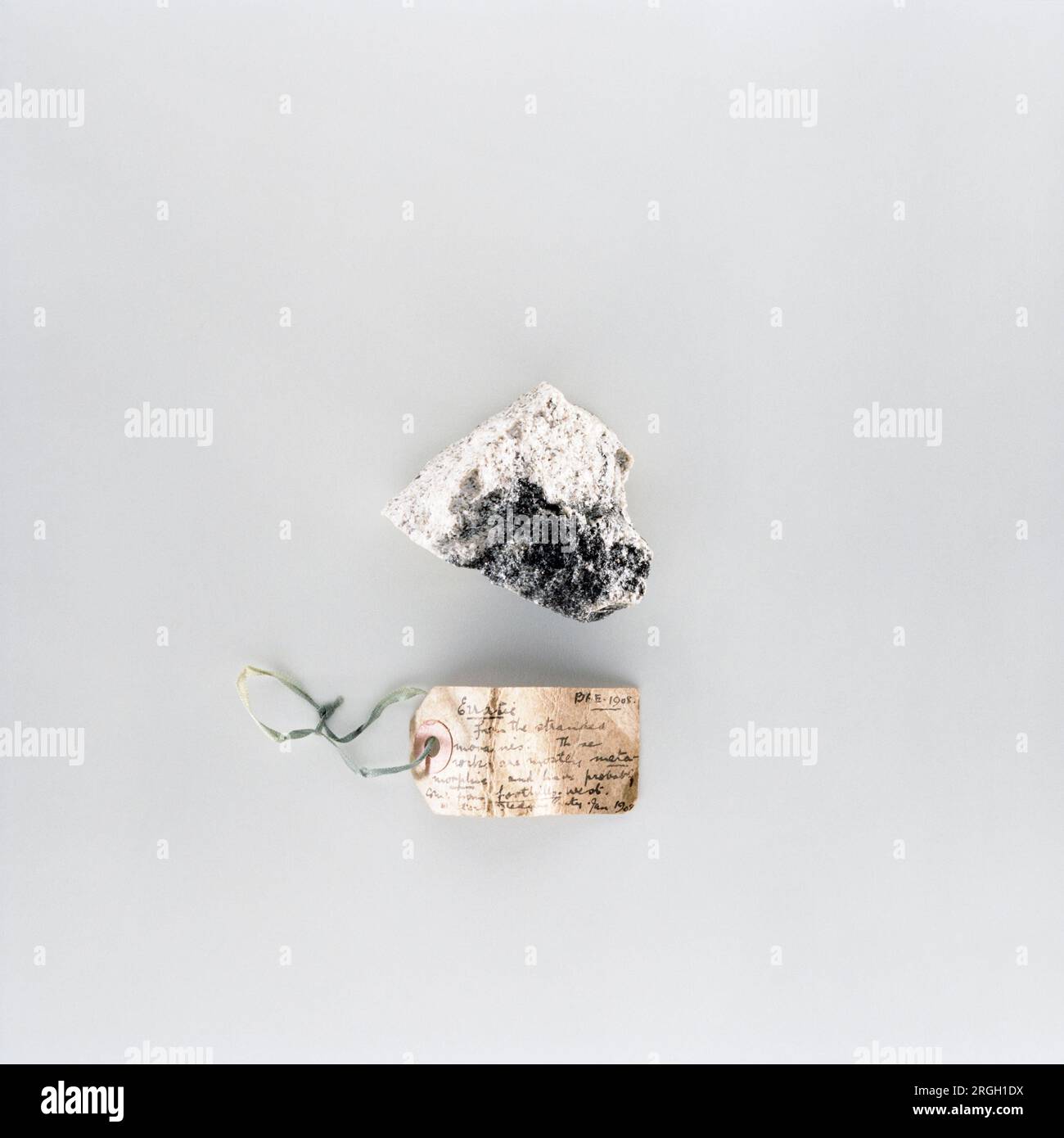 Rock with label on white background Stock Photo - Alamy