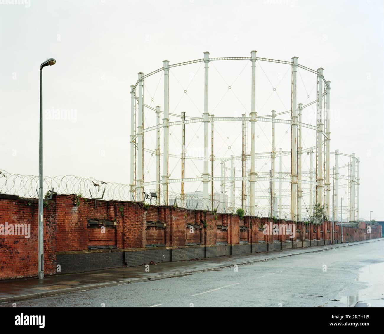 Metal structure behind brick wall Stock Photo - Alamy