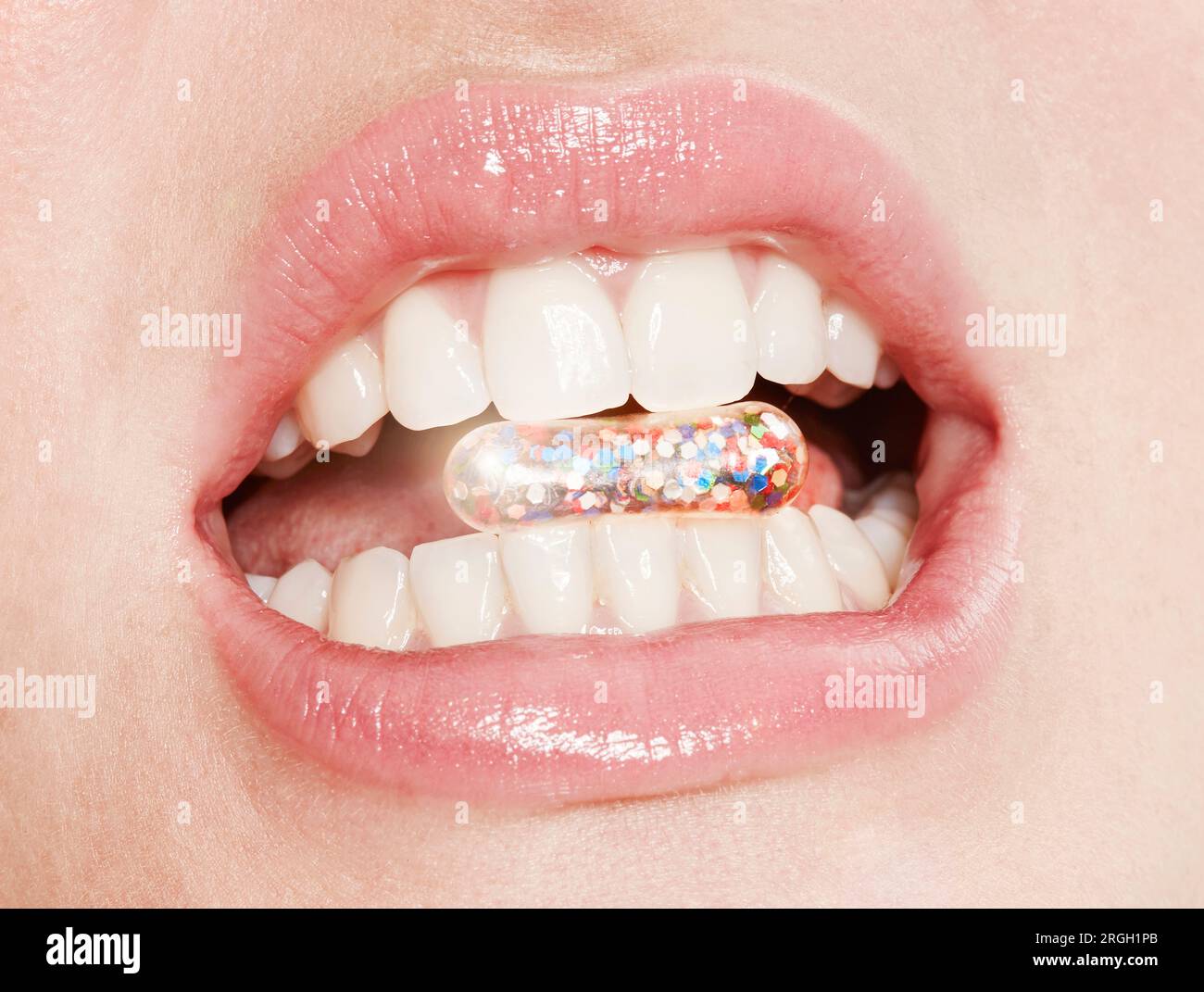 Lips of woman taking glitter capsule Stock Photo - Alamy