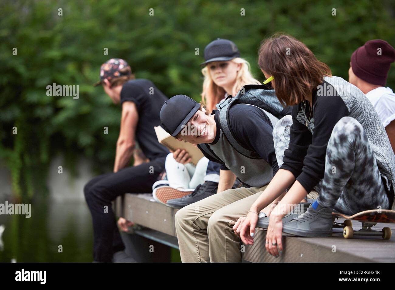 Boy sitting on jetty hi-res stock photography and images - Alamy