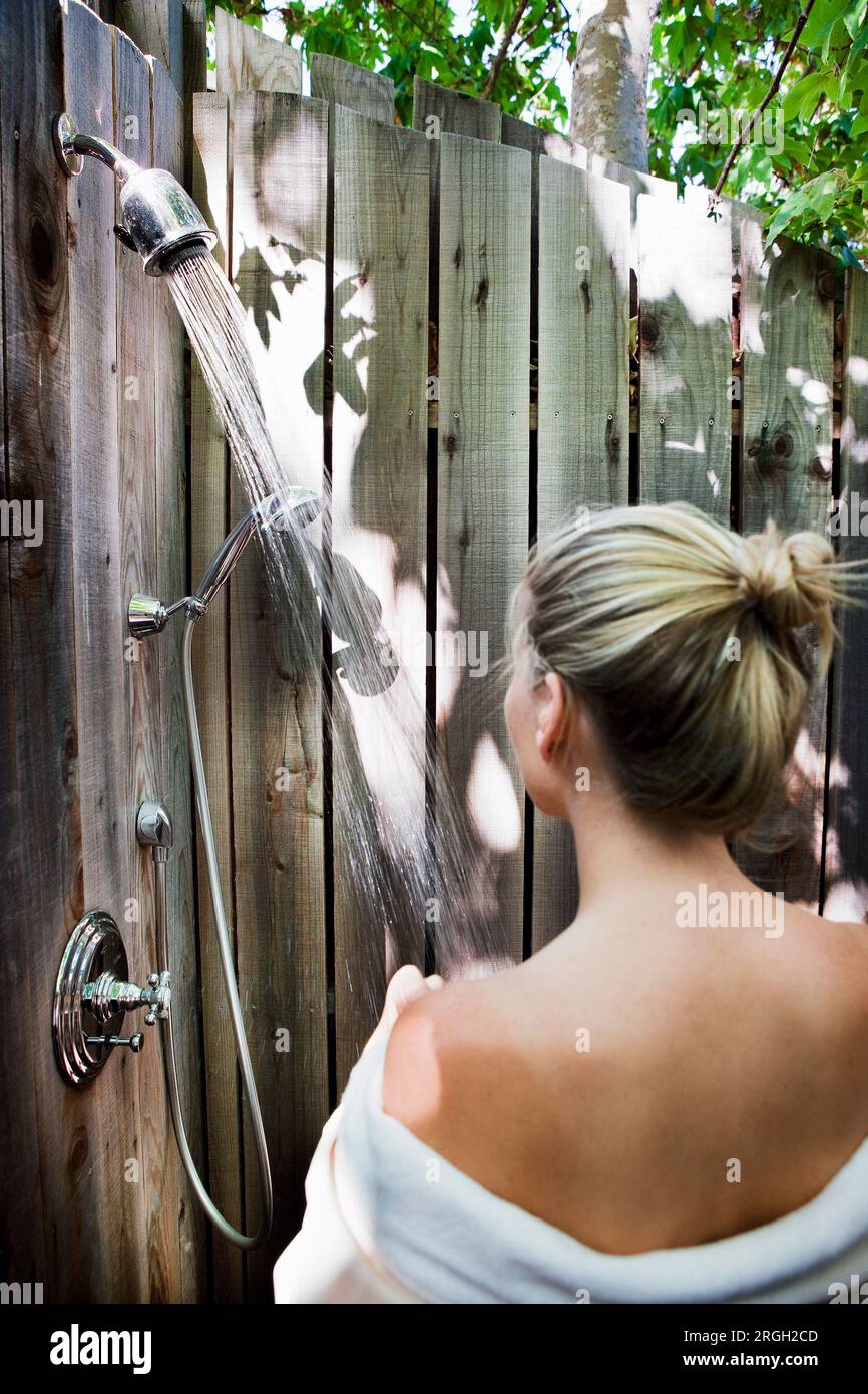 Woman in outdoor shower Stock Photo - Alamy