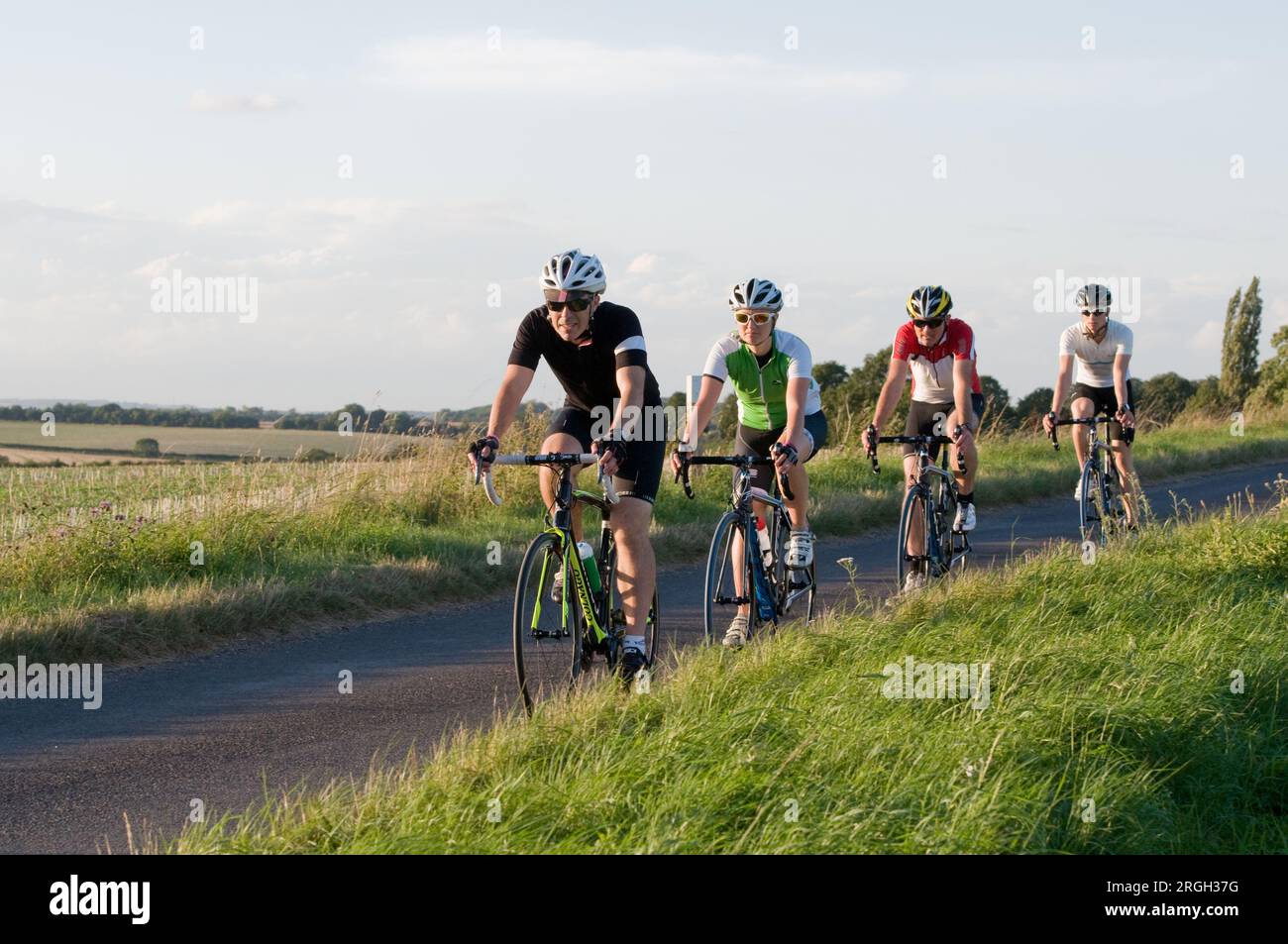 Cyclists riding on country road hi-res stock photography and images - Alamy